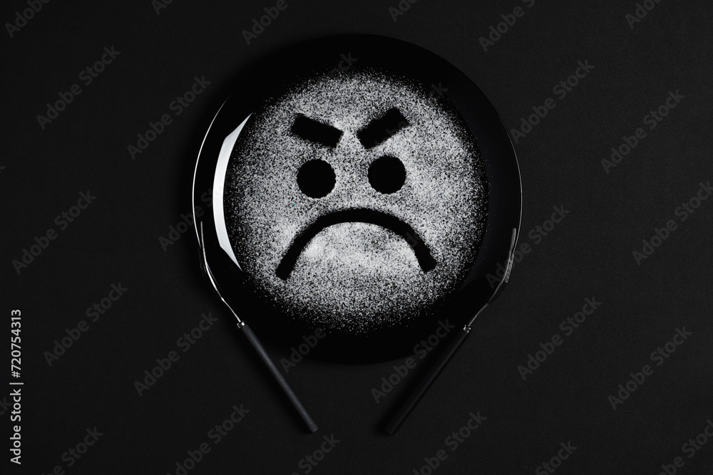 Displeased face, frowning eyebrows, concept made with plate and flour ...
