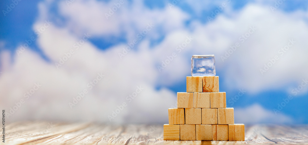 Wooden blocks in a tower with an ice cube on top, climate change icons ...