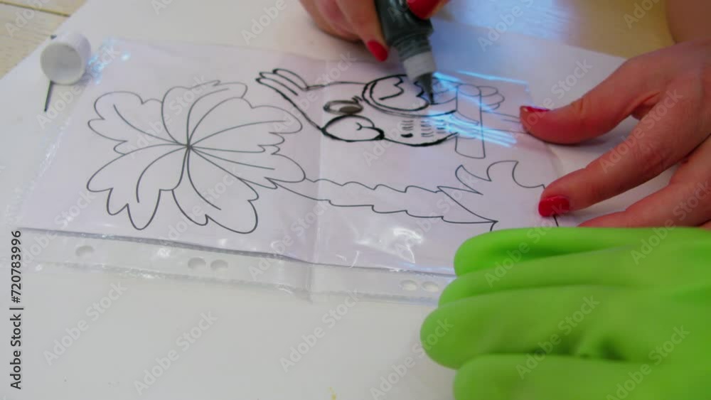 Child learns how to draw by copy of picture on transparent surface ...