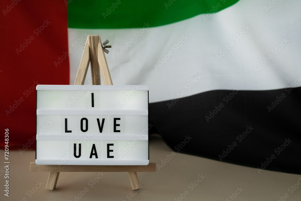 Message text I LOVE UAE on background of waving UAE flag made from silk ...