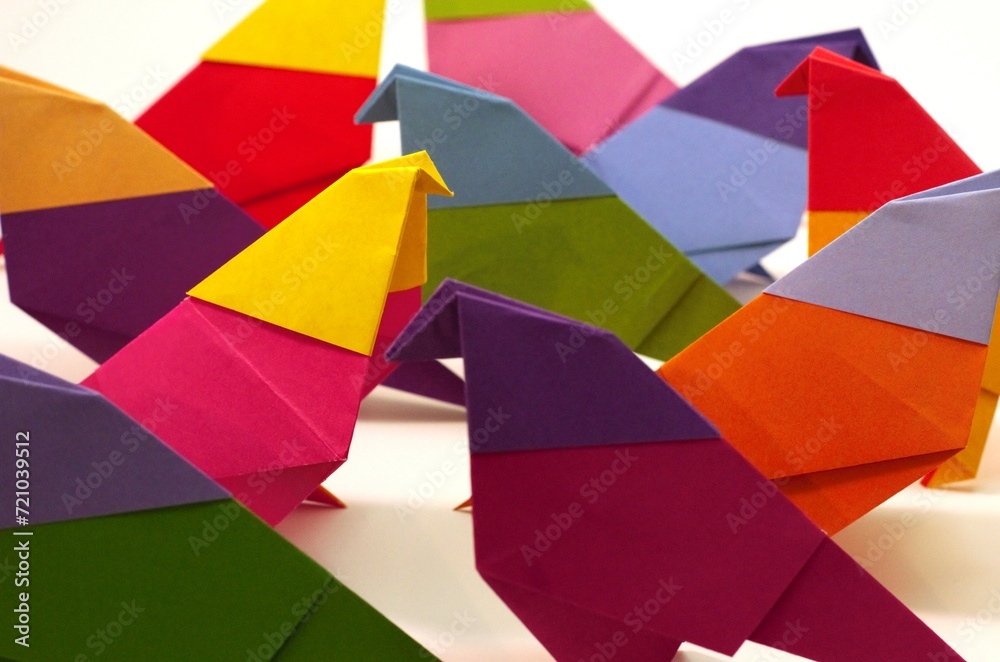Side angle of four or five rows of origami birds passing by each other ...