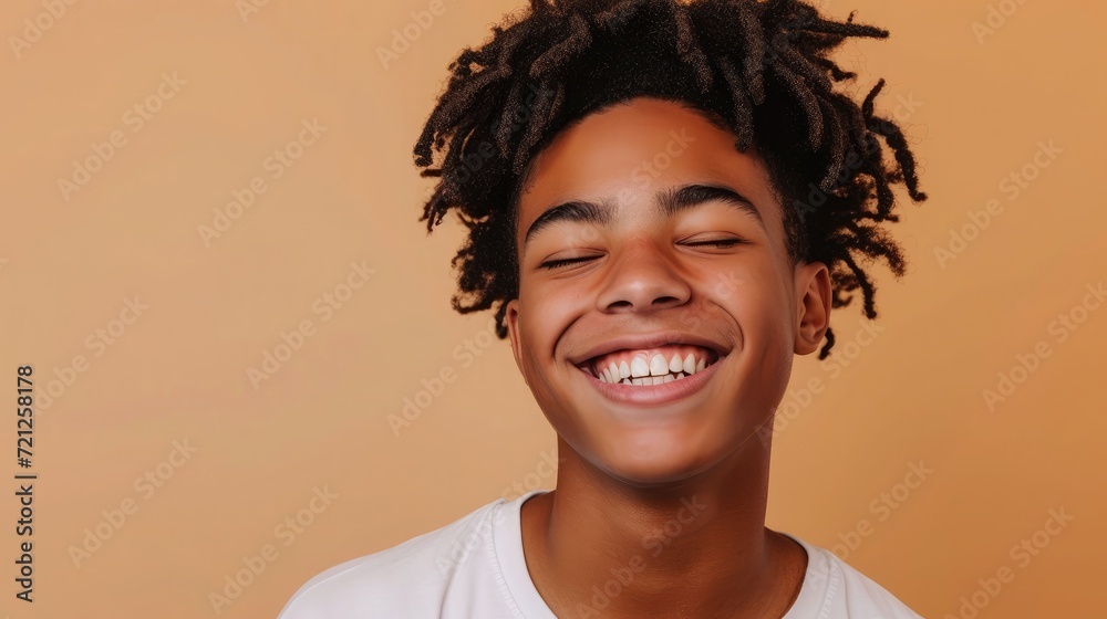 Happy young African American gen z guy winking isolated on beige ...