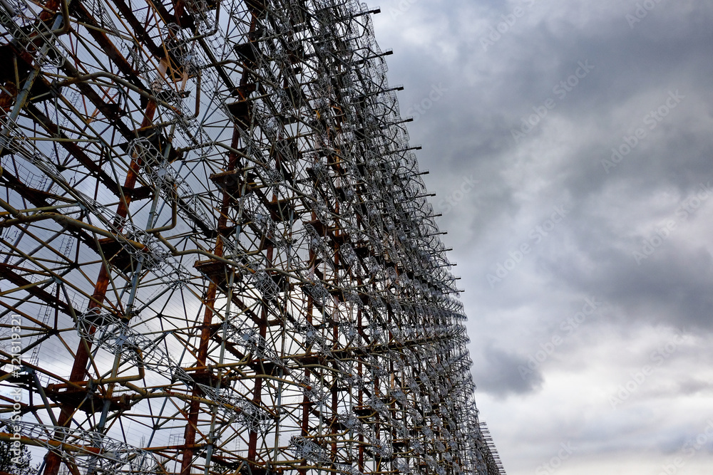 Rusty structures filled with a web of cables and wires. Duga is a ...