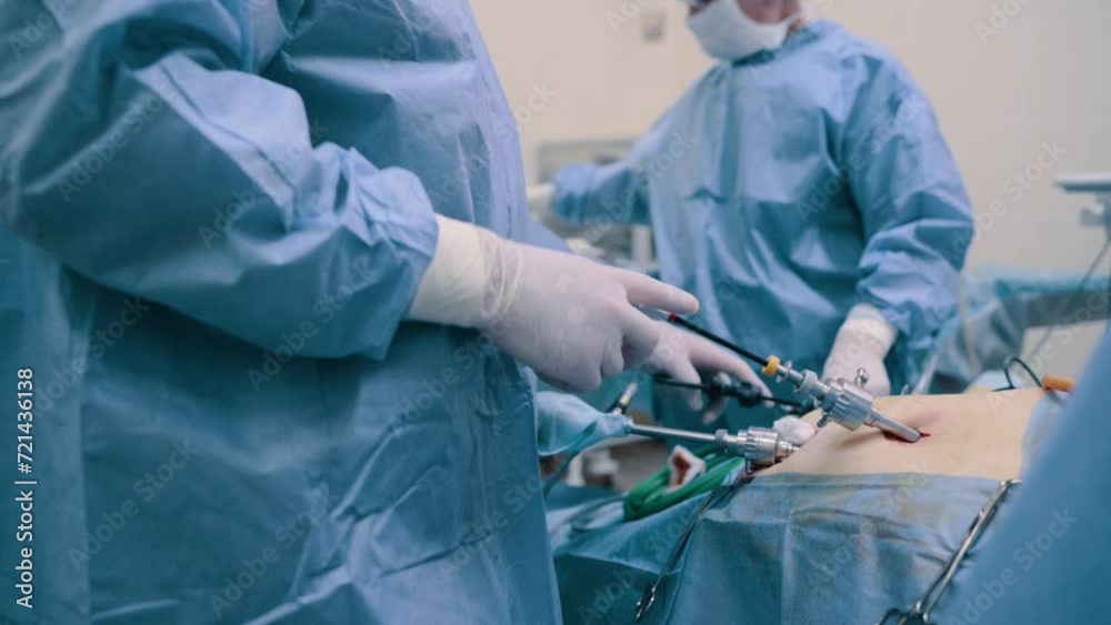 Video endoscopic surgery. The surgeon inserts an endoscope into the ...