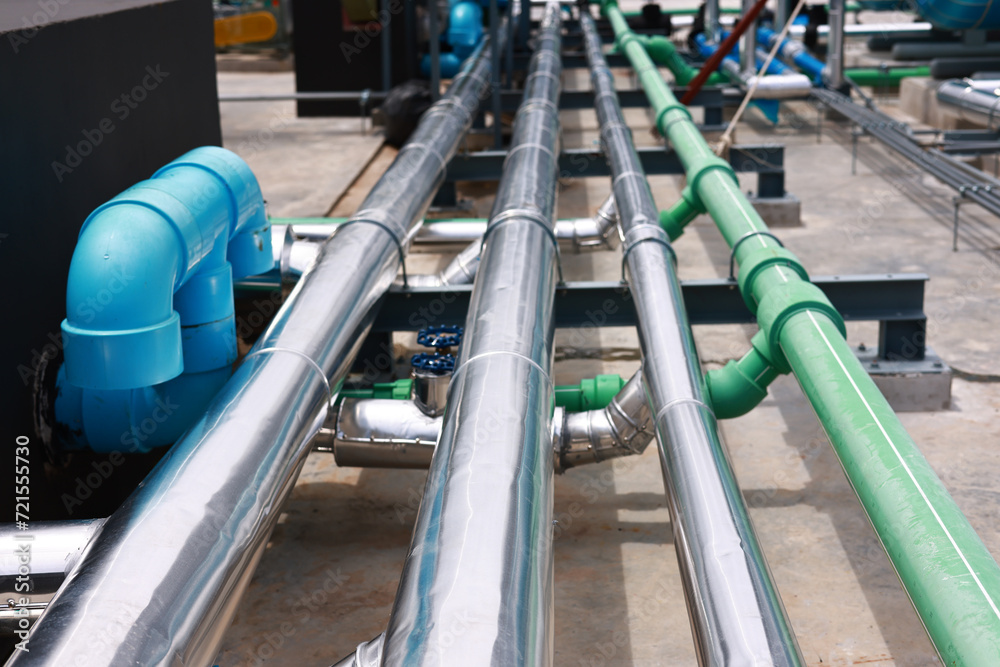 Close-up water piping and cooling piping system on rooftop of building ...