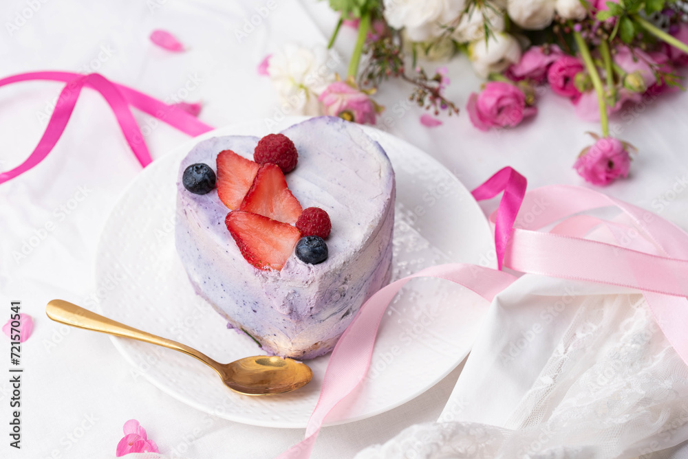 Trendy bento cake in love heart shape form on a light breakfast in bed ...