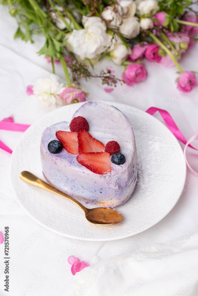 Trendy bento cake in love heart shape form on a light breakfast in bed ...