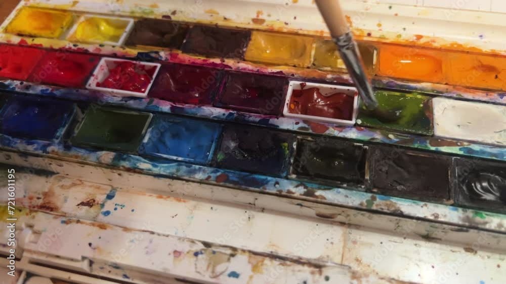 POV painting watercolor in studio. Taking green paint. Process of ...