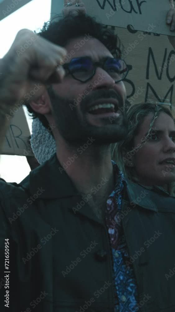 Vertical video. Serious multiracial young group demonstrating against ...
