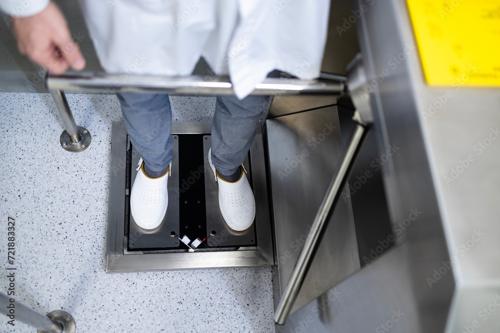 Industrial static eliminator. Factory worker standing on anti-static ...