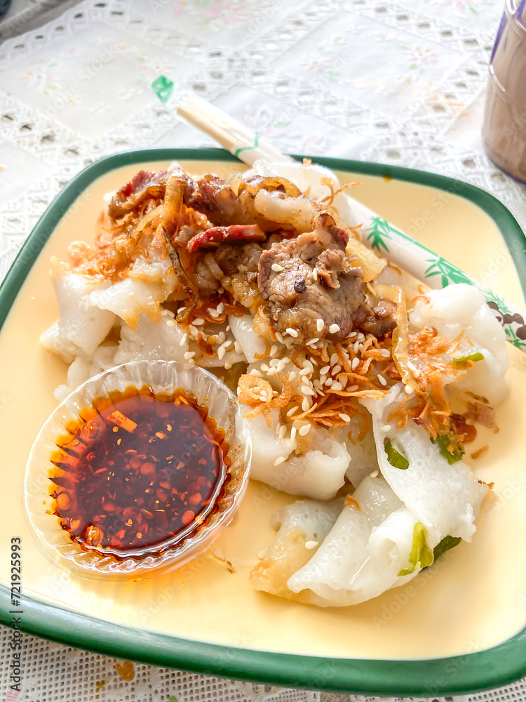 A beef rice noodle roll with chili oil, also known as a steamed rice ...