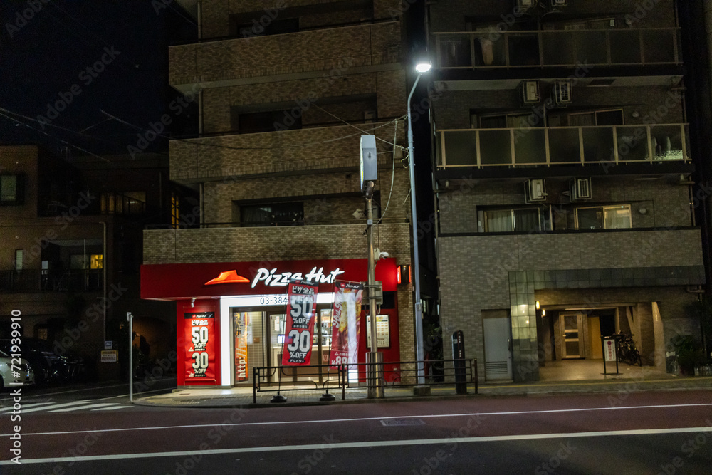 Tokyo, Japan, 1 November 2023: Pizza Hut storefront at night with city ...