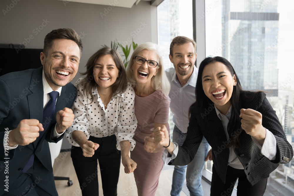 Diverse team of happy young colleagues and older group leader woman ...