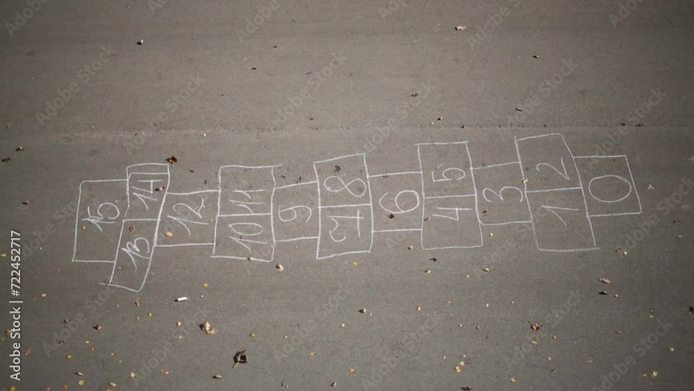 Vidéo Stock Girl playing hopscotch jumping on the numbers on the ...