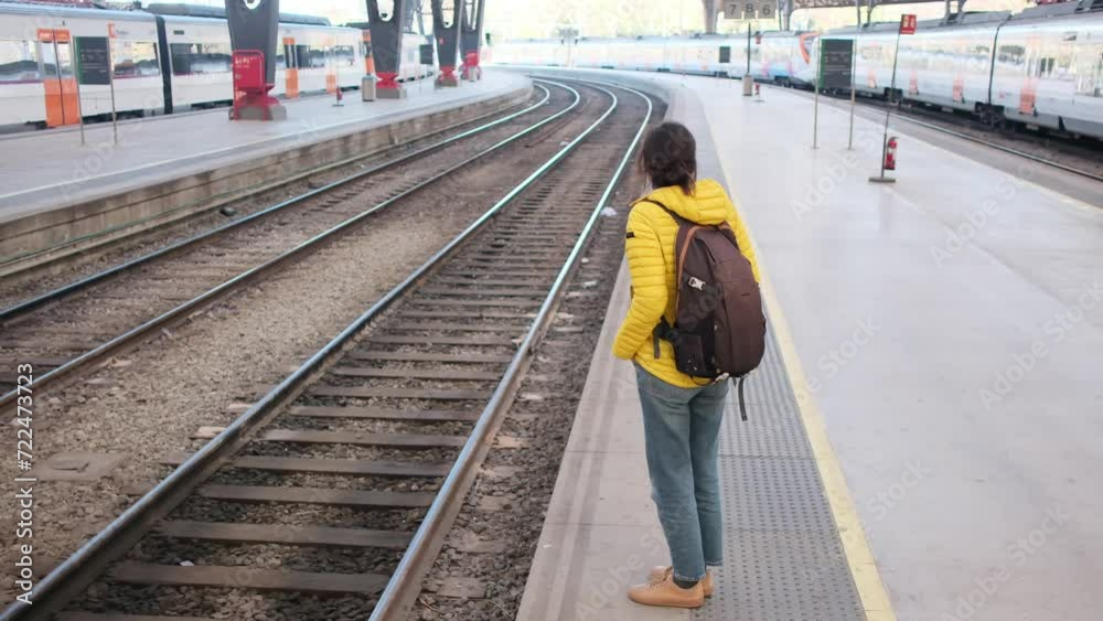Exciting journey awaits young adult women at bustling train station. Boarding trains, embracing ...