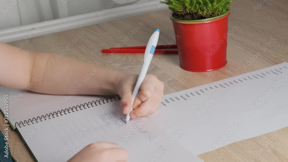 Vidéo Stock schoolchild doing homework, copying words English, child ...