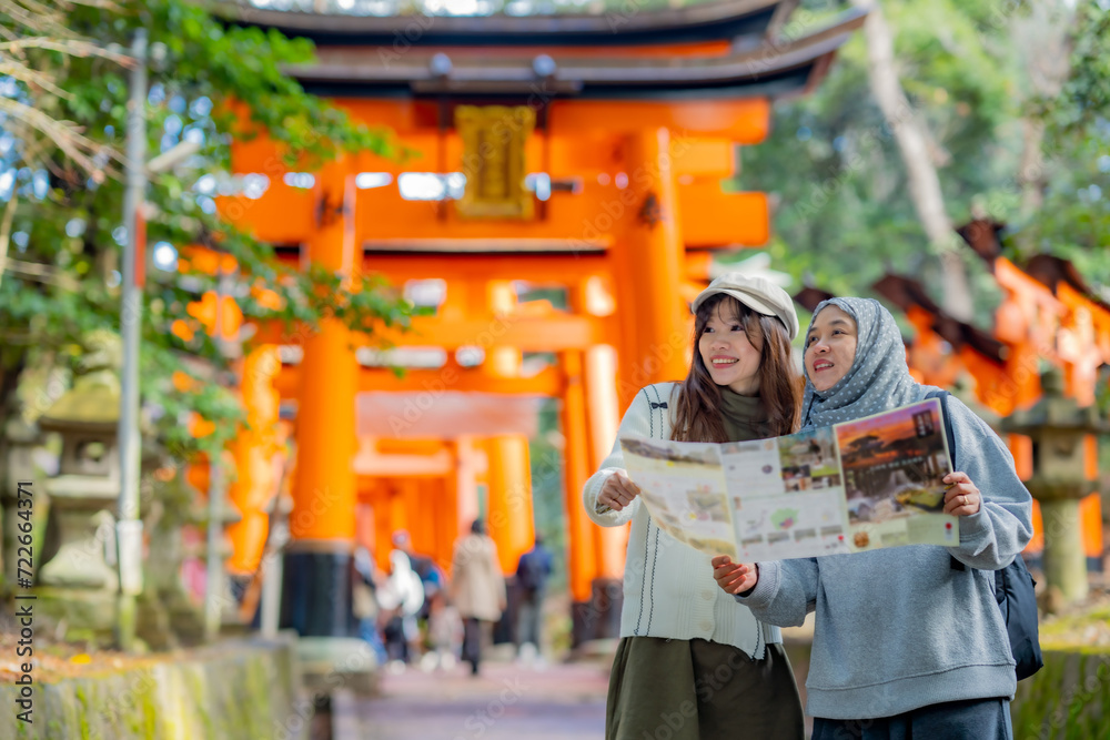 Travel, muslim, Two Asian female tourists of different religions ...