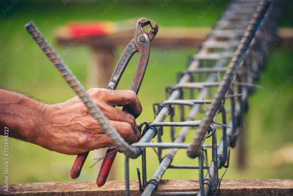 Construction Worker hands using pincer pliers iron wire. Outdoor Worker ...