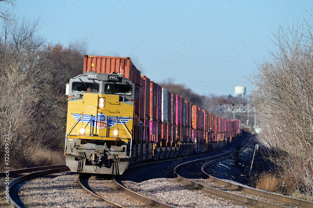 Three locomotives lead a Union Pacific Railroad intermodal freight train into a curve while ...
