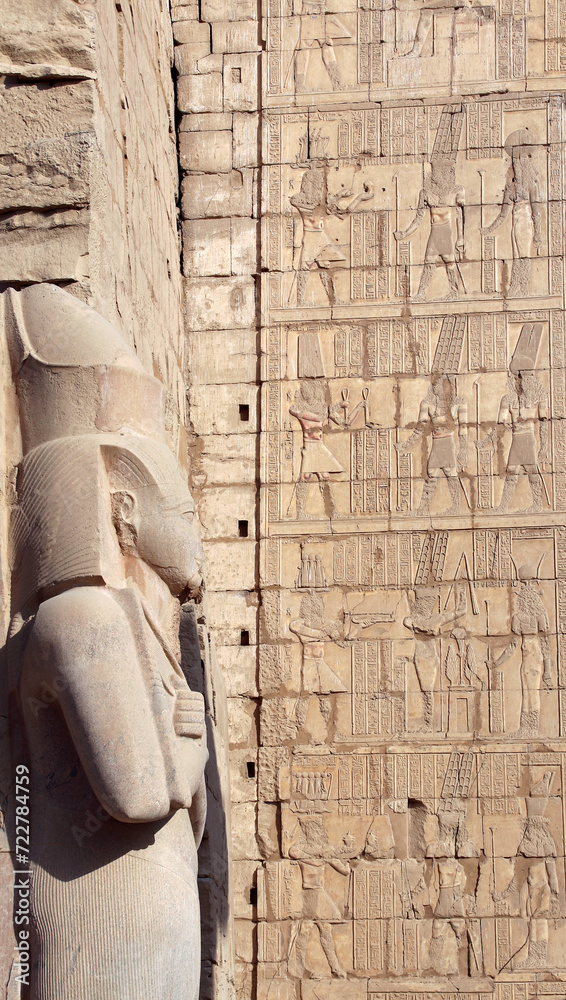 Pharaoh statue and stone wall with hieroglyphs in Karnak Temple, Luxor ... Pharaoh statue and stone wall with hieroglyphs in Karnak Temple, Luxor ...