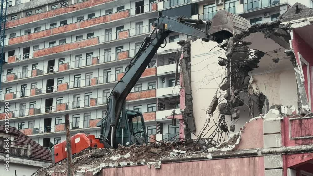 Excavator demolish or remove old ruined building in rainy day. Old ...