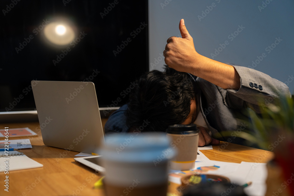 Tired employee businessman sitting work sleep laid his head down on ...