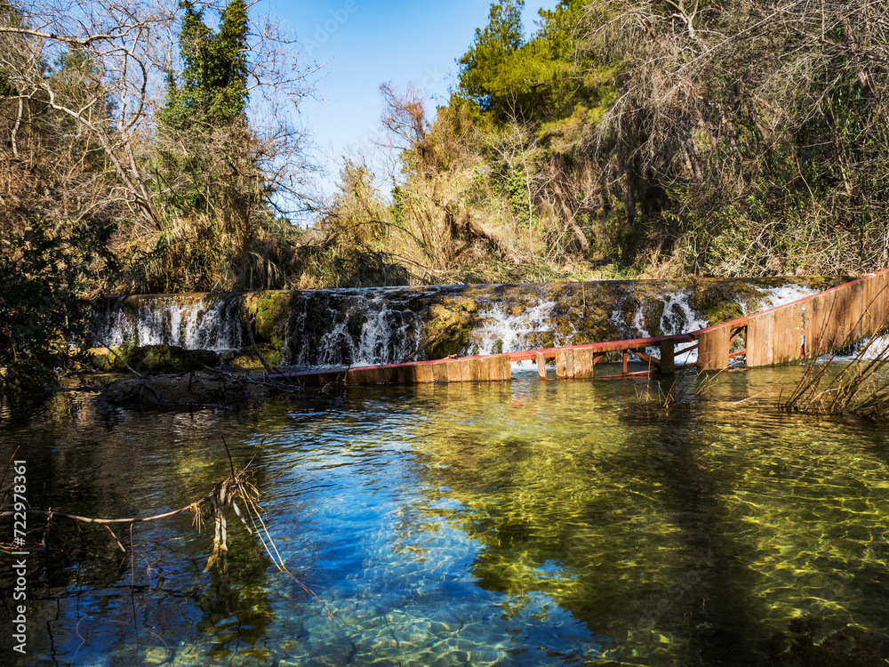 Destroyed old wooden bridge across the river after the rains. The water ...