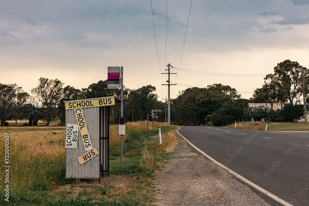 Rural bus stop on the roadside in country Victoria covered in signs ...