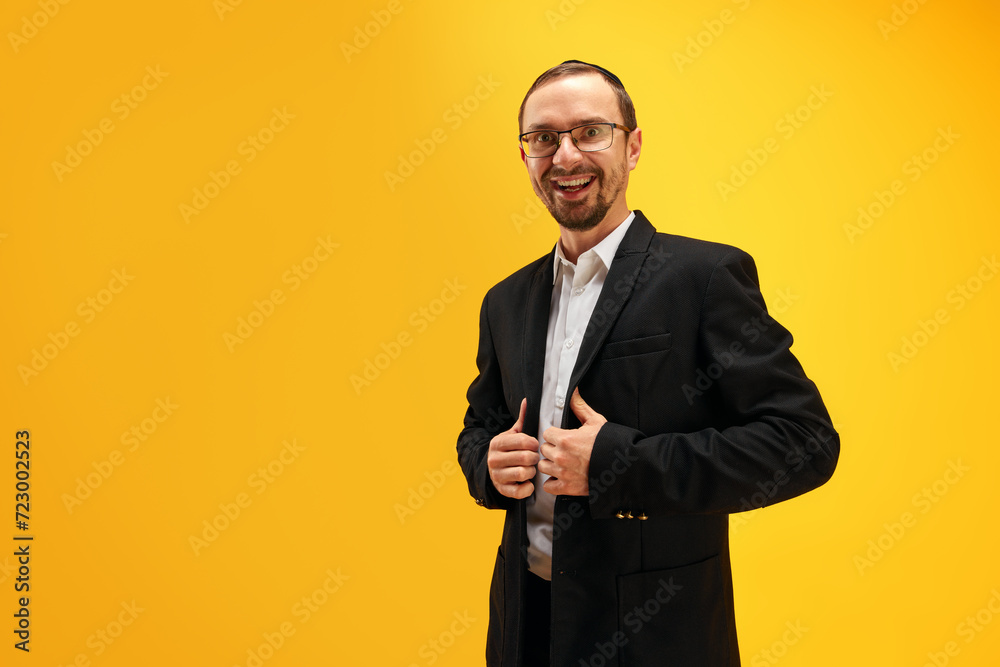 Portrait of emotional, excited Jewish man in black suit, yarmulke ...