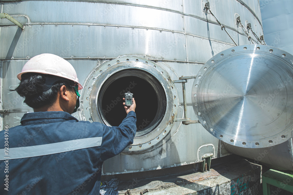 Worker hand holding gas detector inspection safety gas testing at front ...