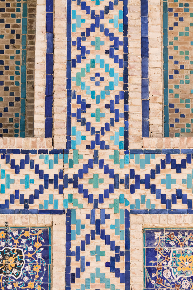 Element of the facade of a madrasah made of brick with mosaic cladding ...
