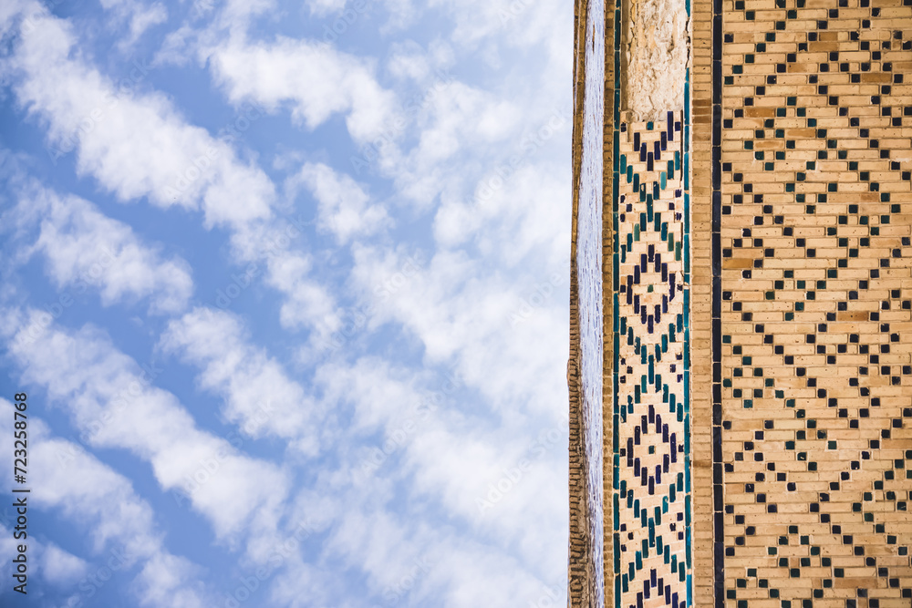 Element of the facade of a madrasah made of brick with mosaic cladding ...