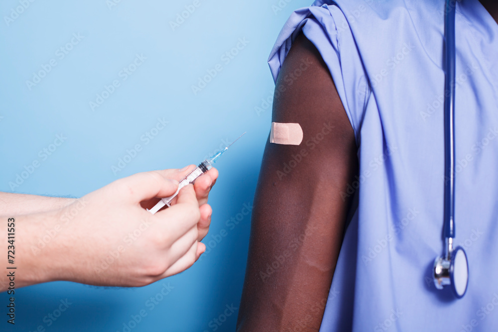 Close-up of caucasian hands with a syringe and needle vaccinating a ...