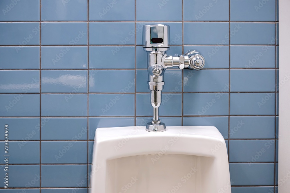 Close up of an auto flushing ceramic urinal toilet with chrome motion ...