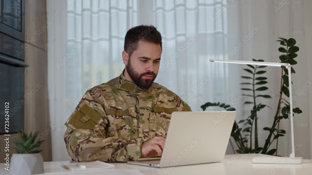 Male army soldier in military uniform using portable computer for ...