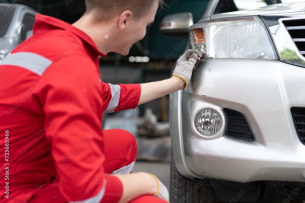 Auto mechanic repairman working on transport body bumper assembly on ...