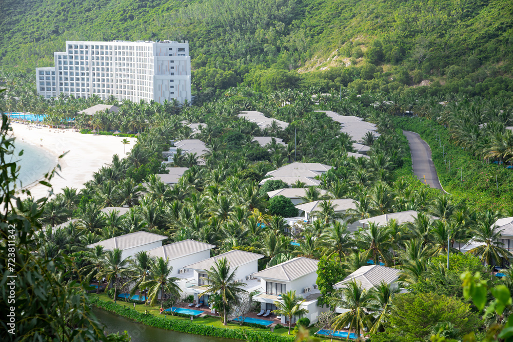 White sandy beach with multistory hotel resort and upscale neighborhood ...