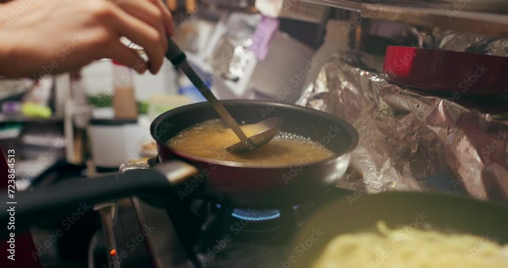 Wideo Stock: Cooking, sauce and person with pan on gas stove at food ...