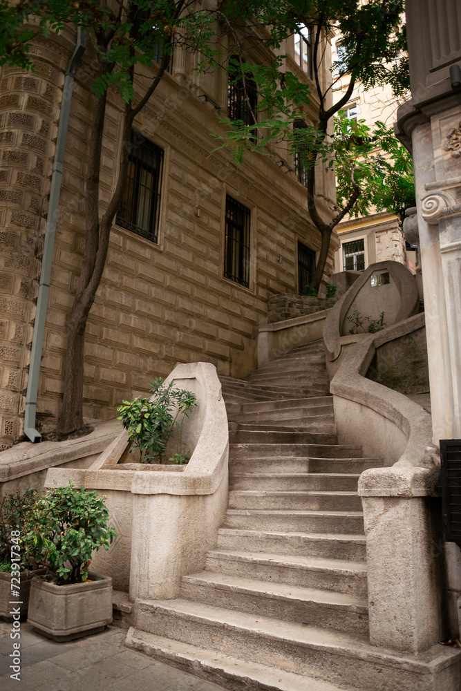 Beautiful spiral staircase in the city. Curly staircase among houses ...