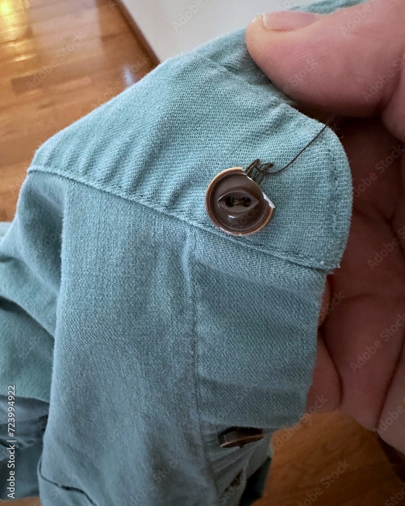 New shirt with a broken button showing poor quality control at the ...