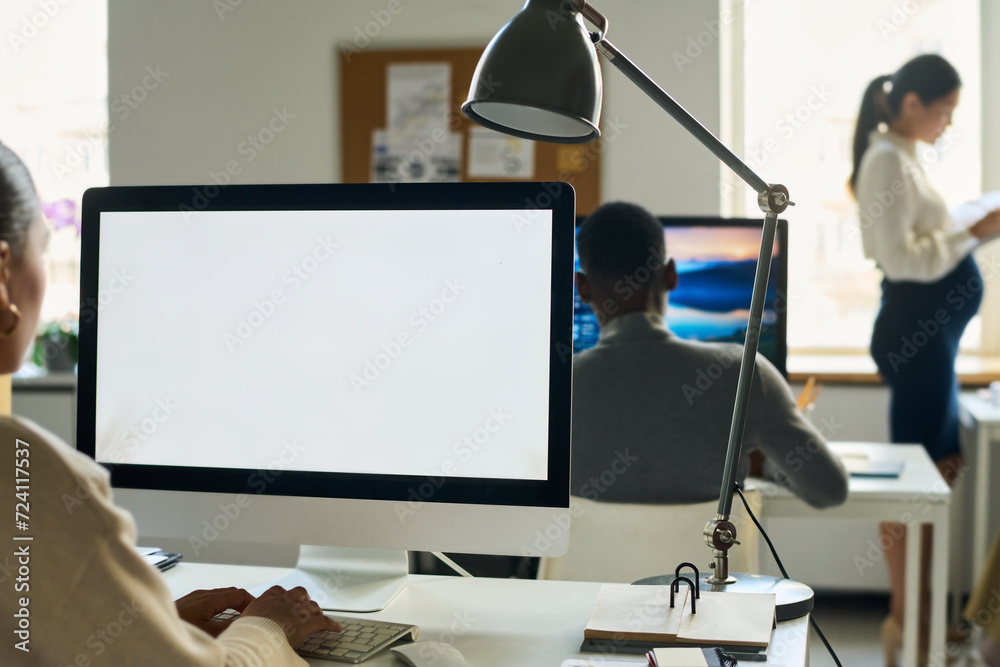Blank screen of desktop computer standing on workplace of office ...