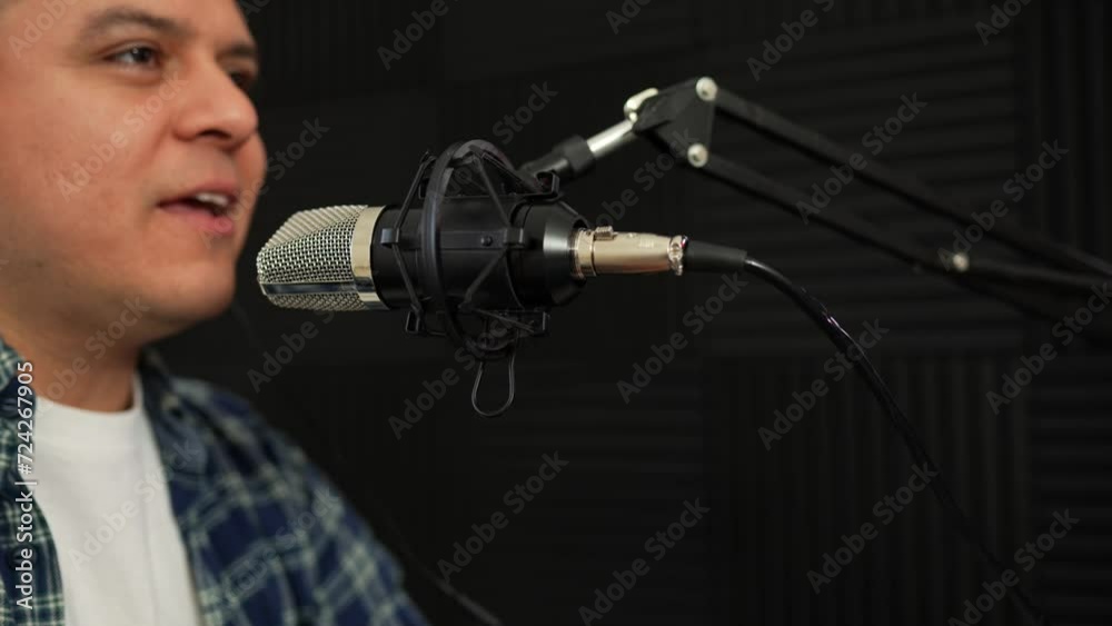Talk show host talking to his audience on a microphone inside a ...