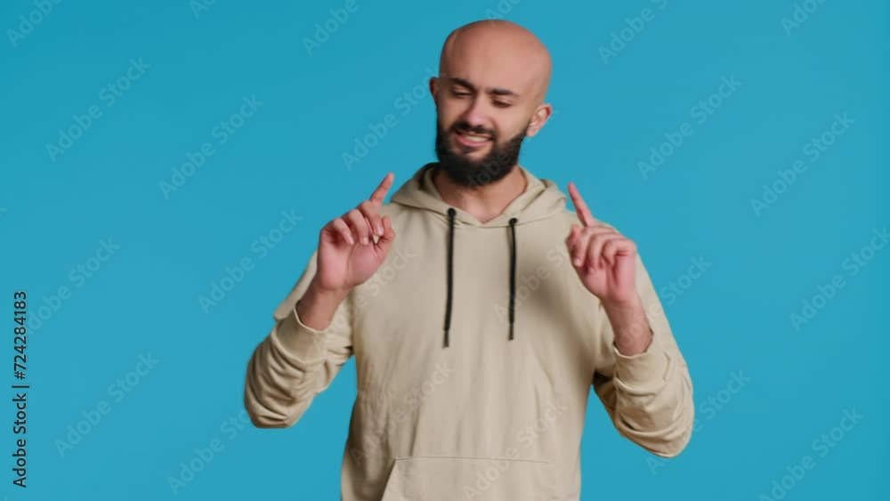 Arab male model doing no symbol on blue backdrop, showing his rejection ...