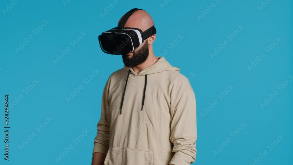 Middle eastern adult using virtual reality glasses in studio, having ...