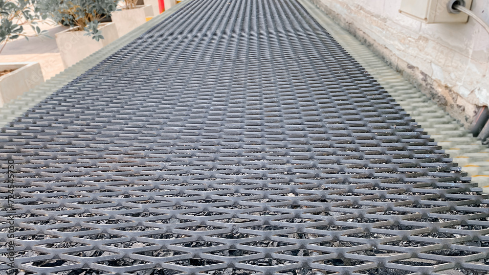 Grating walkway and handrail.External fire escape with open mesh ...