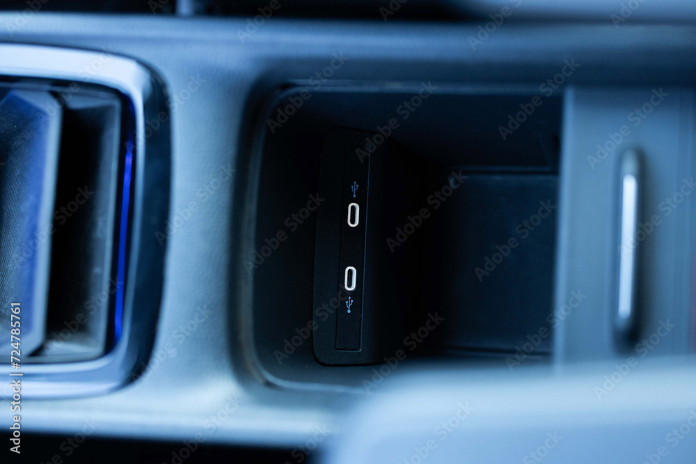 Panel in interior of a new electric car. Two USB C ports in a passenger ...