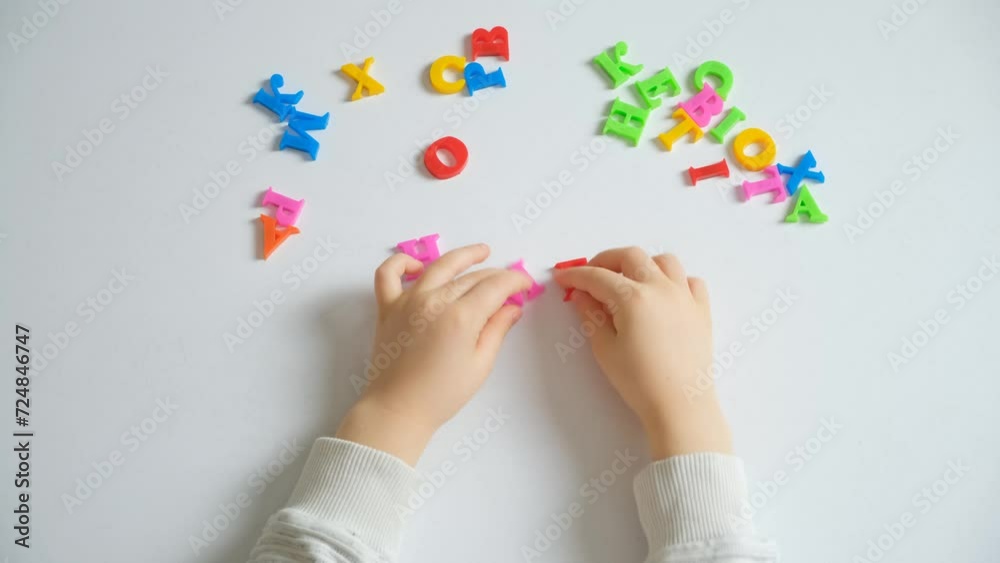 Preschool or elementary school child putting together word home from ...