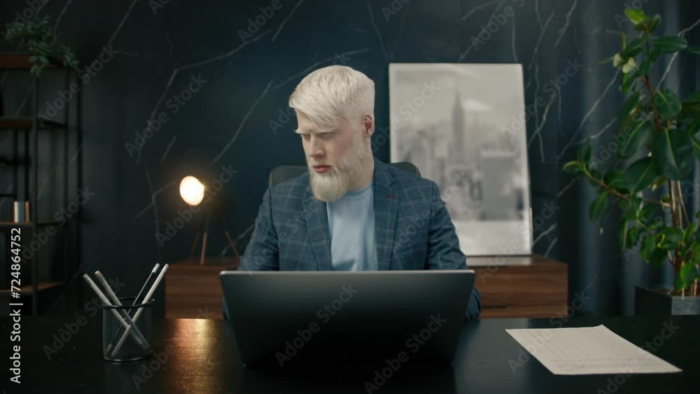 Portrait of albino businessman tired at work in the office. Front view ...