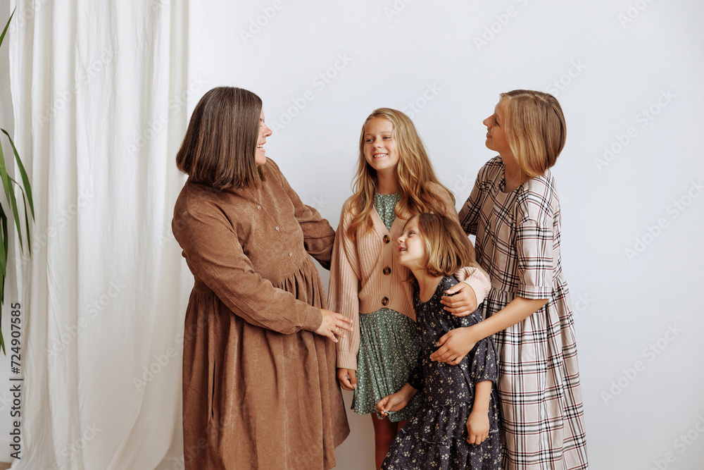 Four Caucasian girls in dresses of pastel and retro colors in a ...
