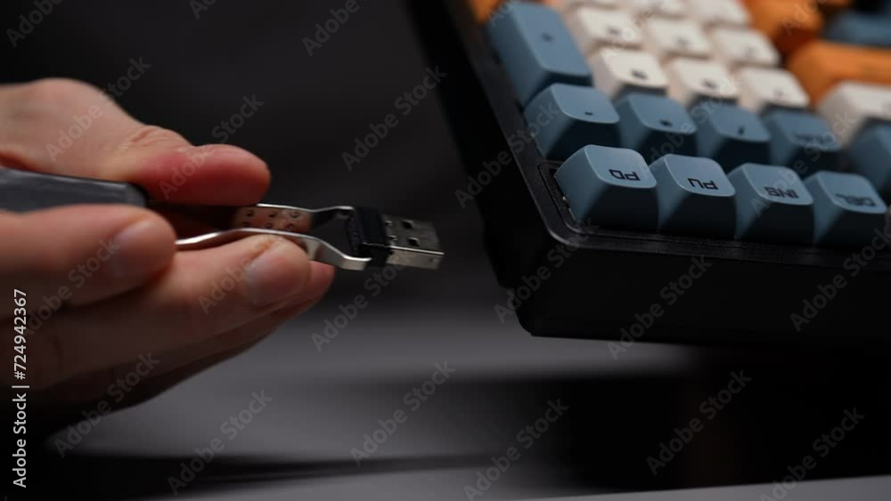 Close-up hands of unrecognizable man using special clip takes out USB receiver to connect ...